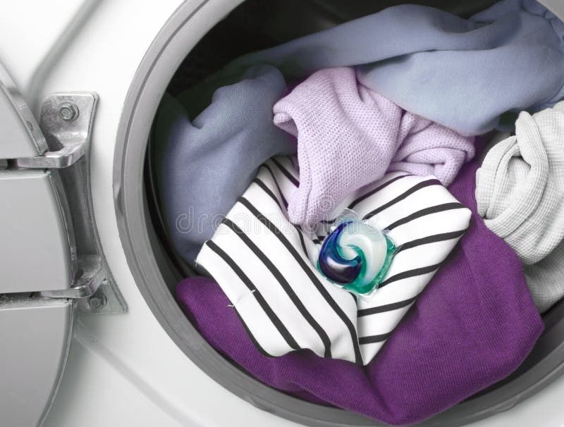 Laundry in Wash Machine with Gel Washing Pod. Laundry Washing Capsule ...