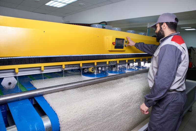 Laundry Worker in the Process of Working on Automatic Machine for ...