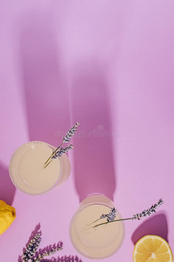 Lavender Lemonade in Ribbed Glasses and Lemons on the Purple Background Stock Photo - Image of ...