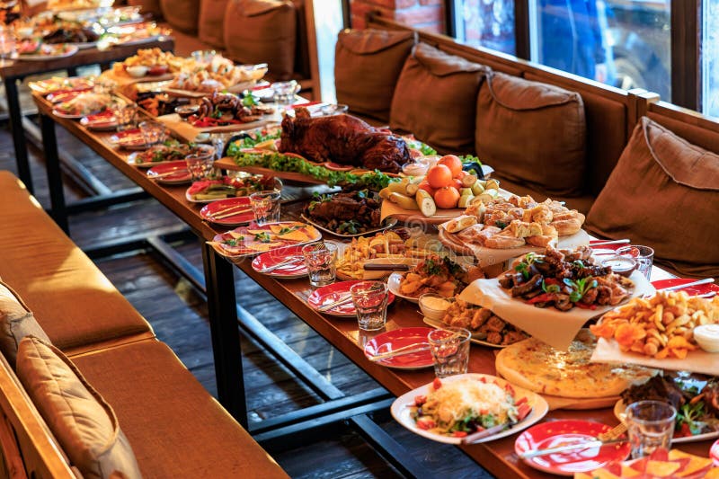 Lavish Feast with Roast Pig and Assorted Dishes on Long Table Stock ...