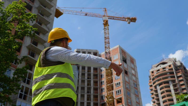 Law Angle View of Handsome Male Builder in Helmet Using Walkie-talkie ...