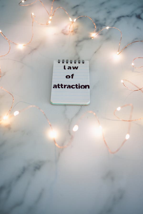 Law of Attraction, Text on Notepad Surrounded by Fairy Lights Stock ...