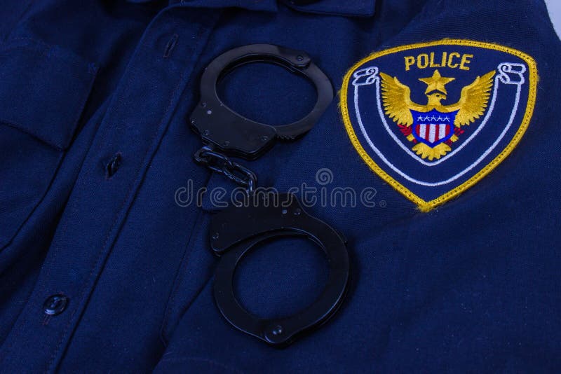 Law Enforcement Uniform with Handcuffs and Generic Police Patch Stock ...