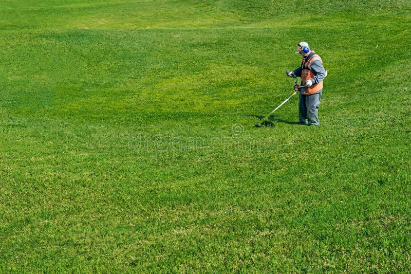 Lawn care. Cutting grass. editorial image. Image of spring - 61957415