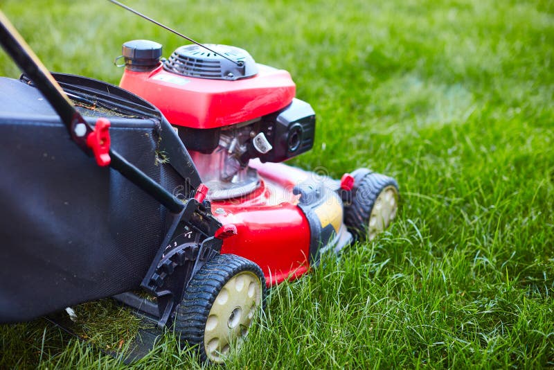 Lawn Mover Cutting High Grass In Garden Stock Photo - Image of task ...