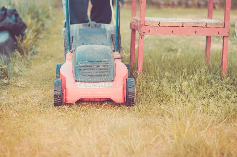 Lawn Mower Cuts a Lawn/red Lawn Mower Cuts a Lawn. Toned Stock Photo ...