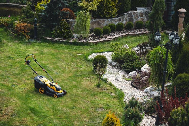 Lawn Mower in the Garden with Trees and Flowers Stock Image - Image of ...