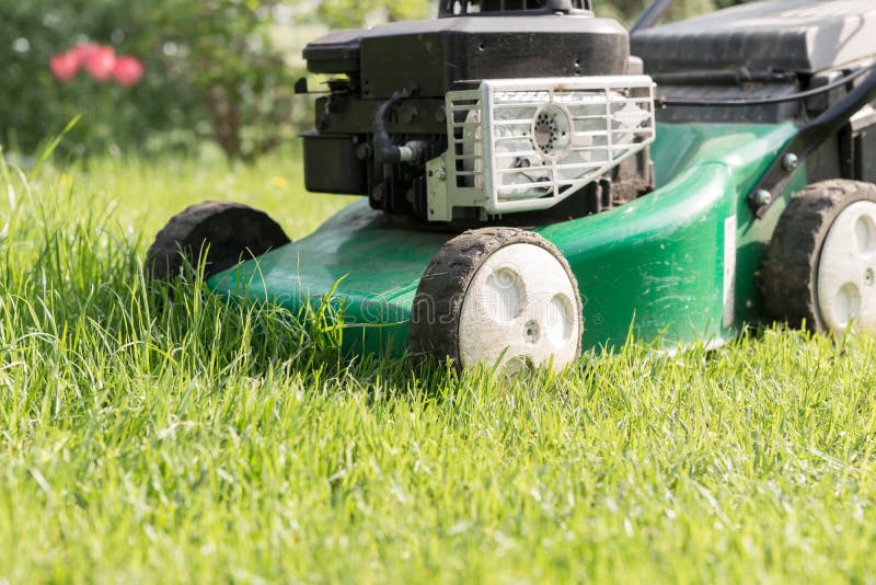 Lawn Mower in the Garden at Work Stock Photo - Image of outdoor ...
