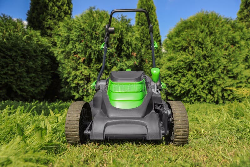 Lawn Mower on Green Grass in Garden Stock Photo - Image of backyard ...