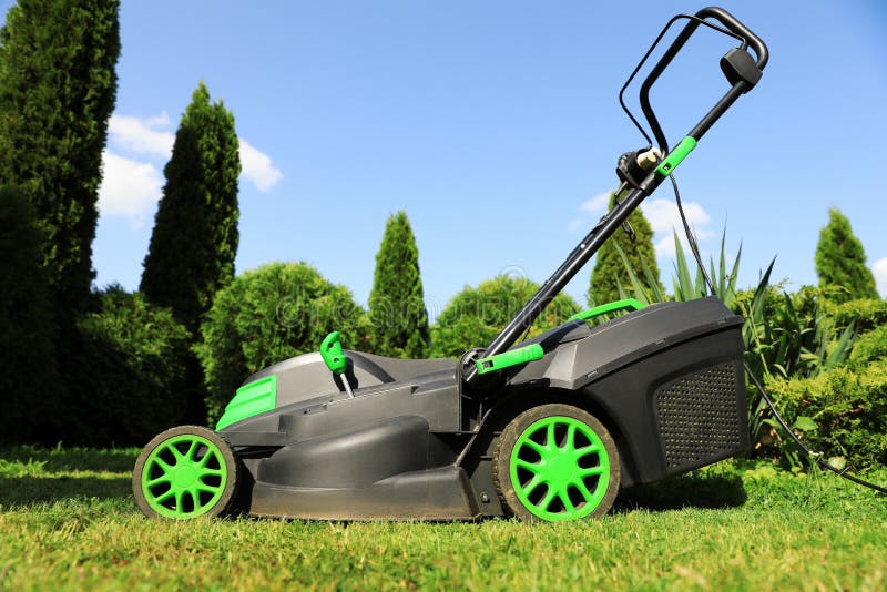 Lawn Mower on Green Grass in Garden Stock Photo - Image of engine ...