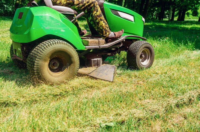 Lawn Mower Rides on the Lawn and Mows the Grass. Mowing the Lawn in the ...