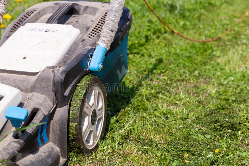 Lawn Mower in the Spring Garden Stock Image - Image of scythe, mowing ...