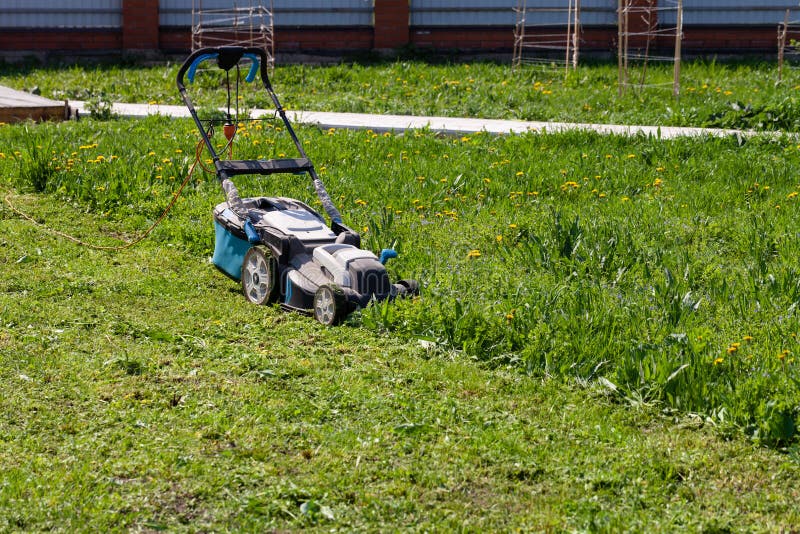 Lawn Mower in the Spring Garden Stock Image - Image of maintain, field ...