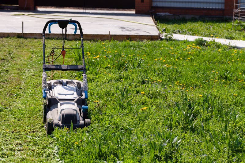 Lawn Mower in the Spring Garden Stock Image - Image of fence, metall ...