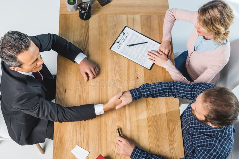 Lawyer and Client Discussing Contract at Workplace with Laptop Stock ...