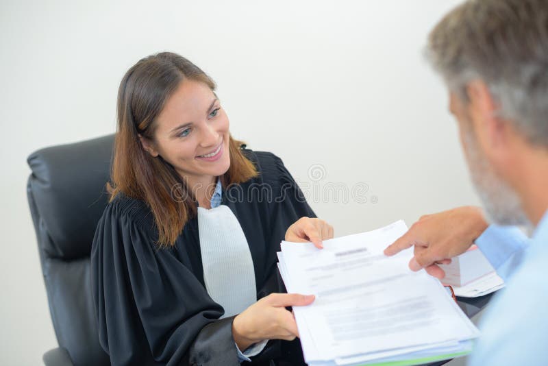 Lawyer Looking at Paperwork with Man Stock Image - Image of defence ...