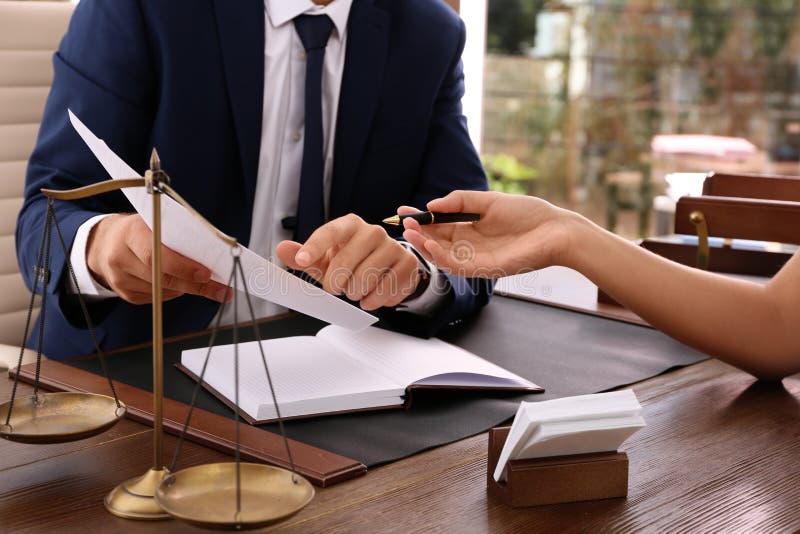 Lawyer Working with Client at Table in Office Stock Photo - Image of ...