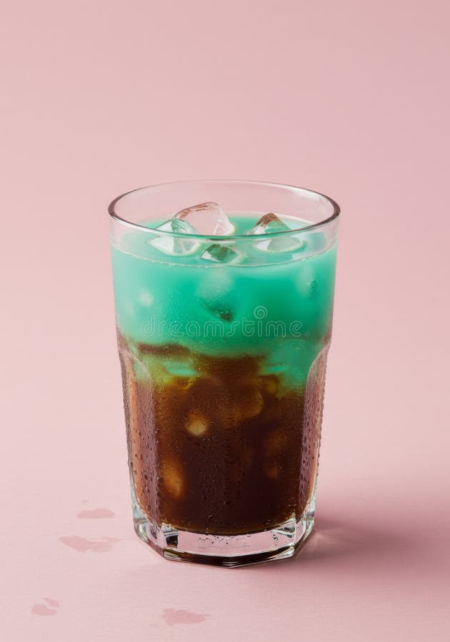 Layered Blue and Brown Iced Drink in Glass on Pink Background Stock ...