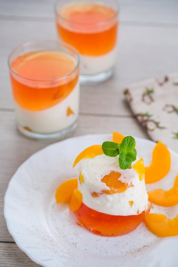 Layered Fruit Dessert with Jelly, Cream and Fresh Mint on a Wooden ...