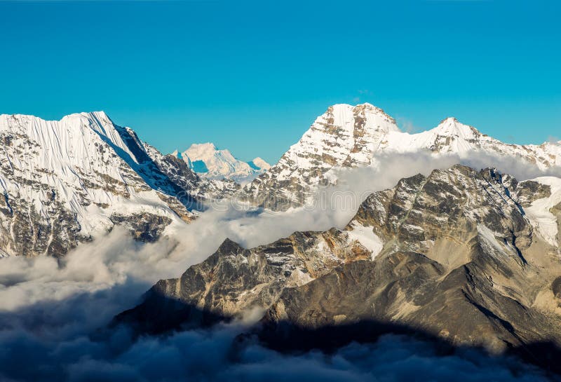 Layered Mountains View with Lights and Shadows Clouds in Valley Stock ...