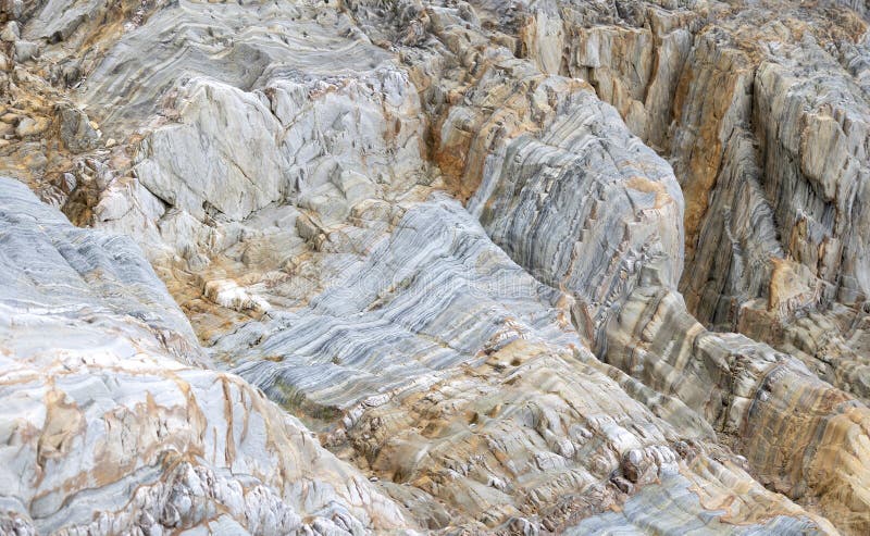 Layered Rock Formations Featuring Gray and Orange Hues with Intricate ...