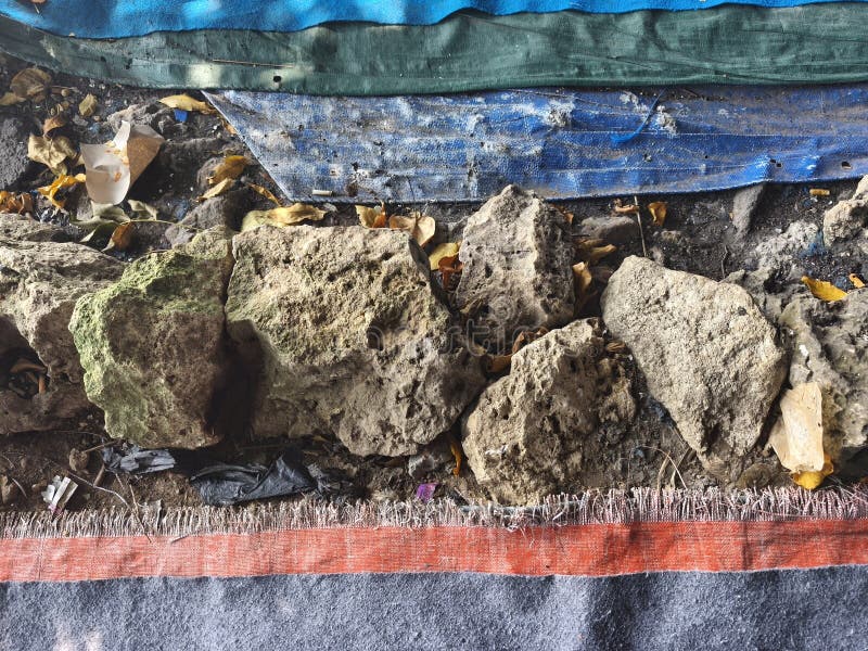 Layered Textures of Fabric, Rocks, and Mixed Debris, Hinting at ...
