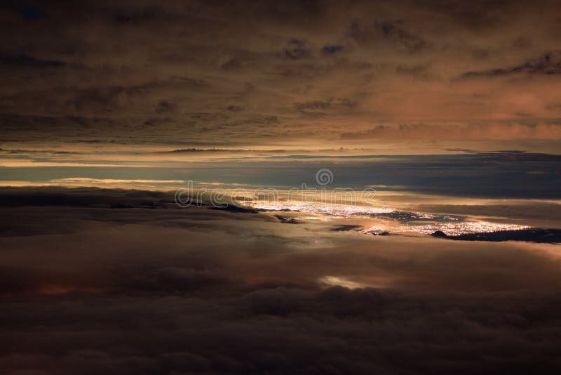 High Elevation View of Layers of Clouds Over Lights from Distant City ...
