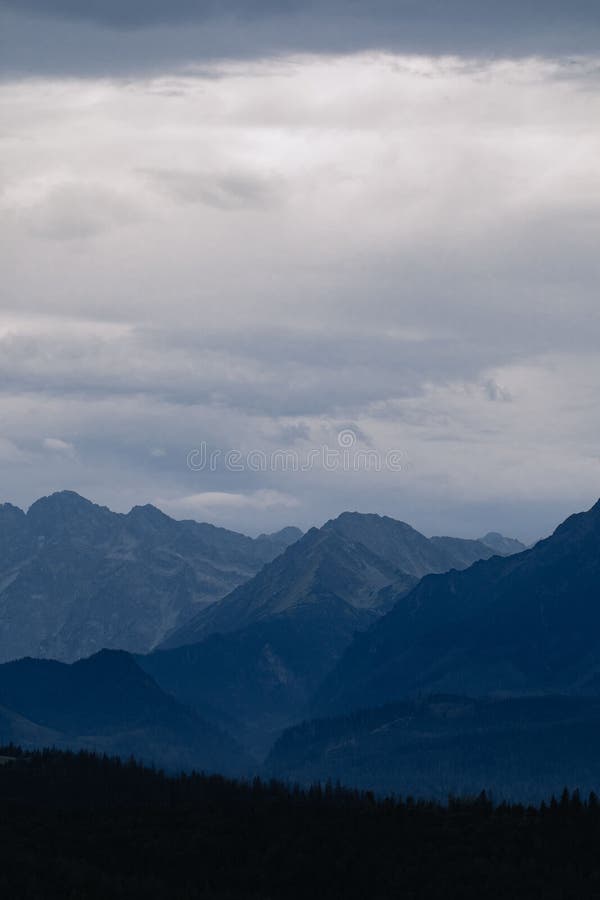 Layers of Mountain Range in Shades of Blue, Vertical Stock Image ...