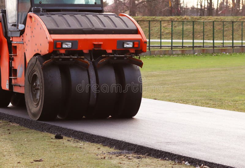 Laying Asphalt with the Help of Heavy Special Equipment. the ...