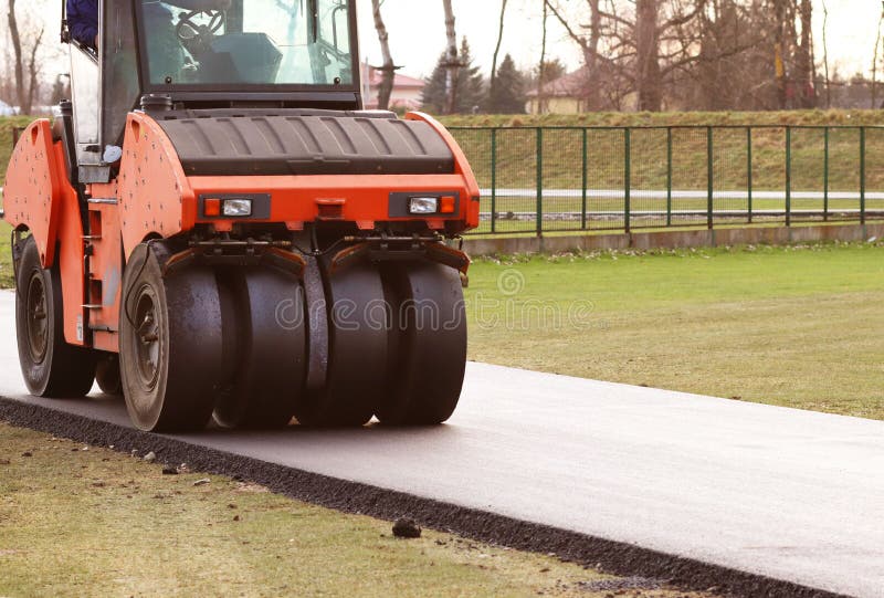 Laying Asphalt with the Help of Heavy Special Equipment. the ...