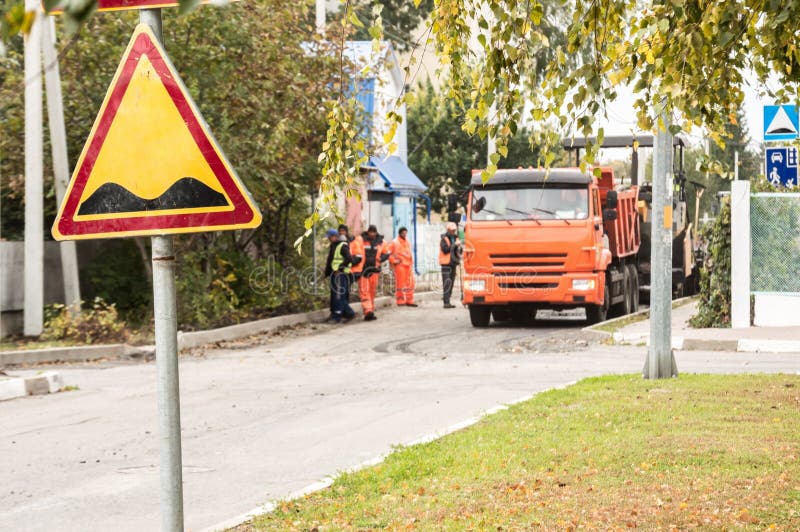 Laying of Asphalt. Road Sign `Speed Bump` Stock Image - Image of ...