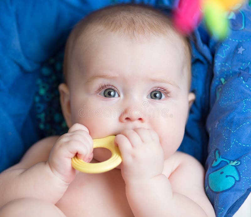 Laying Baby Girl Using Teether Stock Photo - Image of rock, girl: 45521712