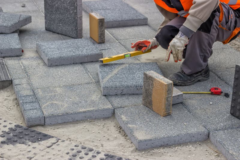 Laying brick pavers stock image. Image of material, shape - 48054531