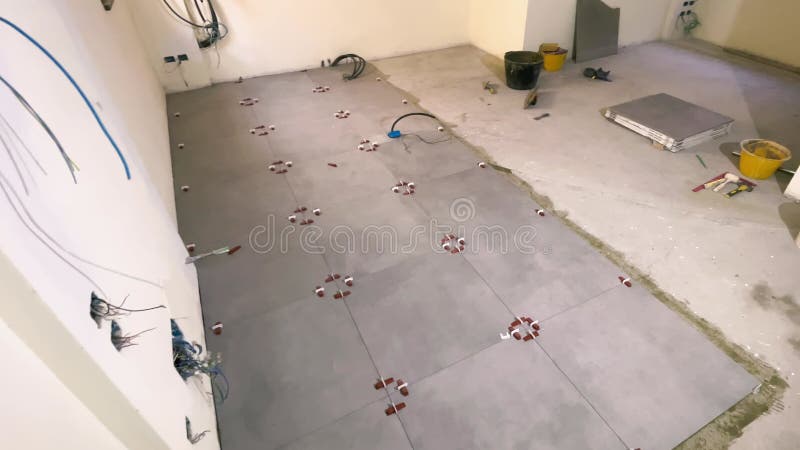 Laying the Ceramic Tiles on the Basement Room Floor Stock Video - Video ...