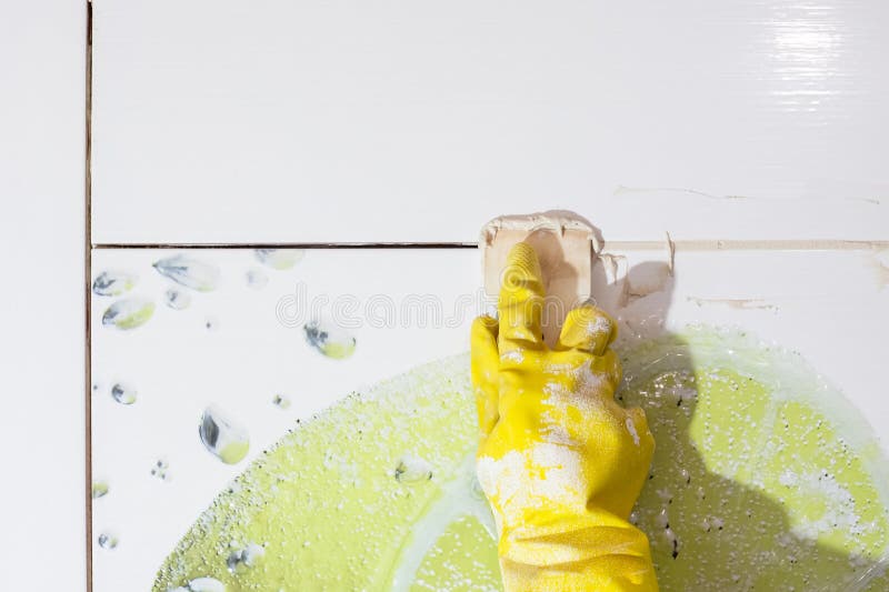 Laying Ceramic Tiles. the Craftsman Fills the Tile Joints with Grout ...