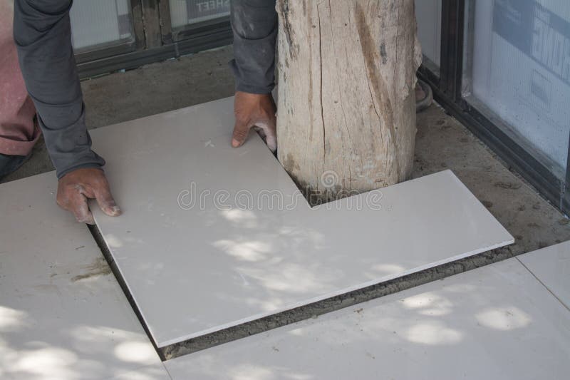 Laying Ceramic Tiles on Floor Stock Image - Image of tiles, human ...