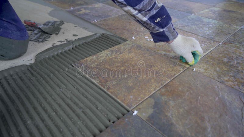 Laying Ceramic Tiles on the Floor, the Master Puts the Tile on the Tile ...