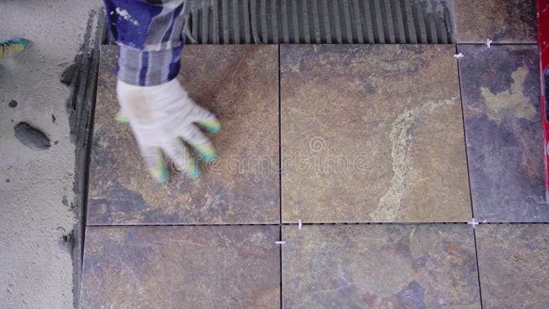Laying Ceramic Tiles on the Floor, the Master Puts the Tile on the Tile ...