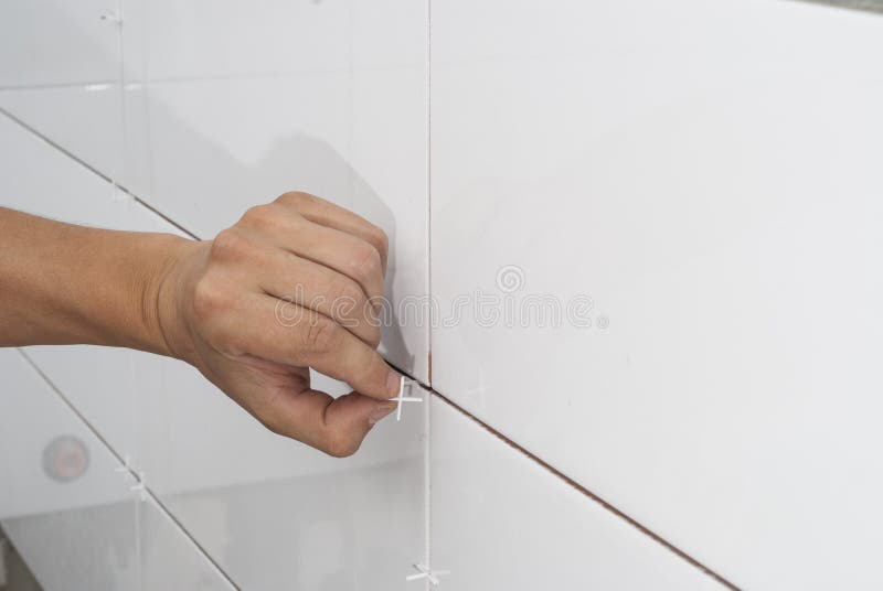 Laying ceramic tiles stock photo. Image of construction - 74598314