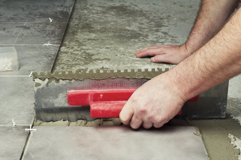Laying ceramic tiles. stock photo. Image of architecture - 78796738