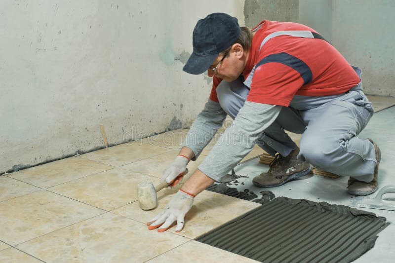 Laying Ceramic Tiles. stock photo. Image of concrete - 49136380