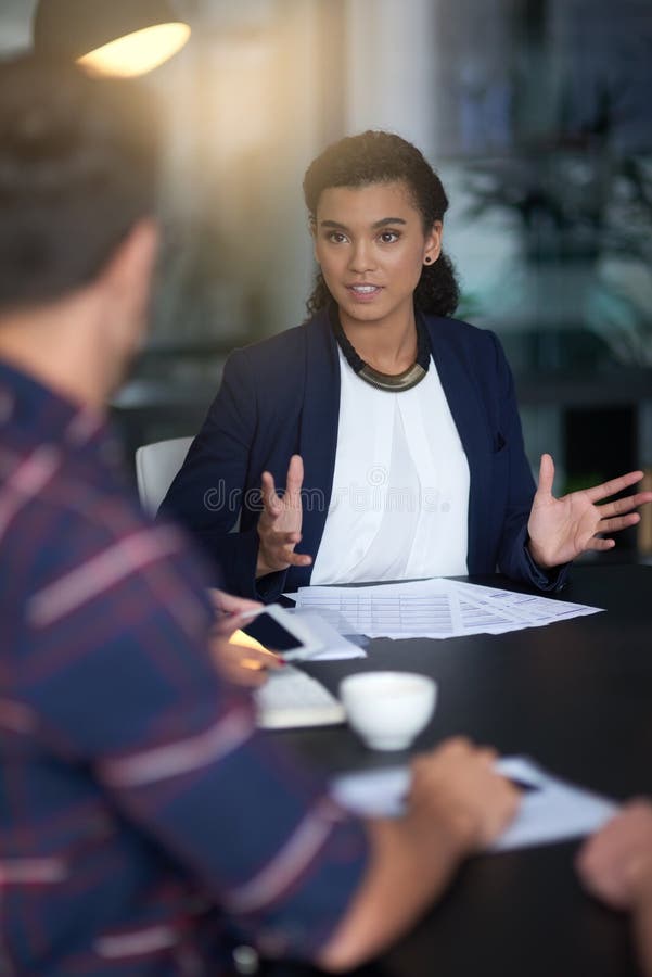Laying Down Her Plan. Shot of a Young Professional Leading Her Team ...