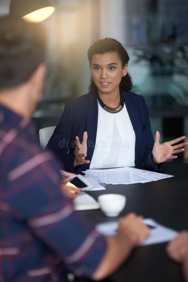 Laying Down Her Plan. Shot of a Young Professional Leading Her Team ...