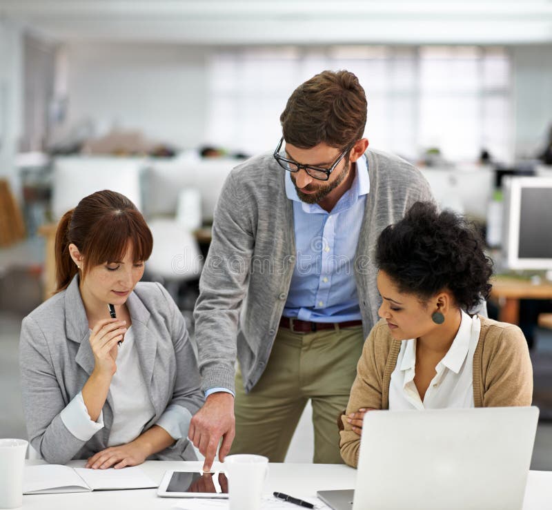 Laying Down Some Business Wisdom. a Group of Young Office Professionals ...