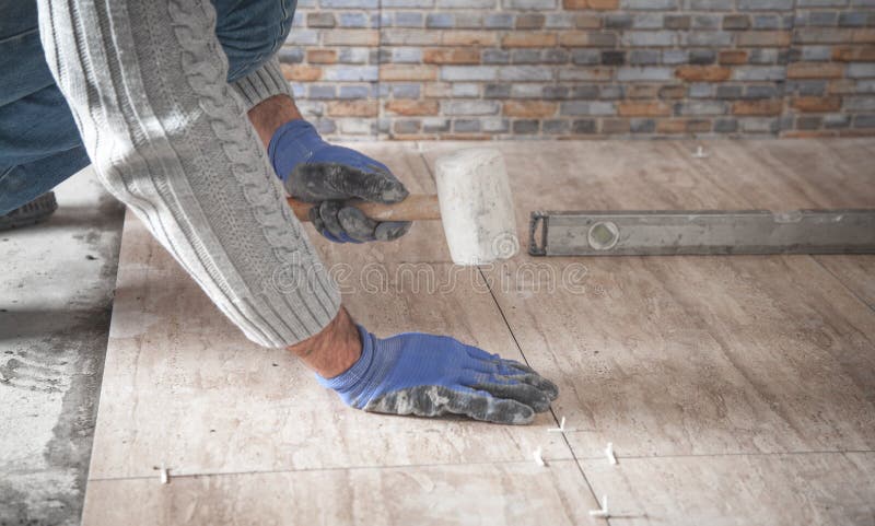 Laying Floor Ceramic Tile. Renovating the Floor Stock Image - Image of ...