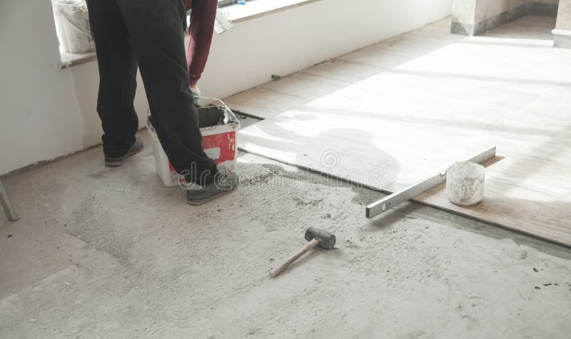 Laying Floor Ceramic Tile. Renovating the Floor Stock Photo - Image of ...