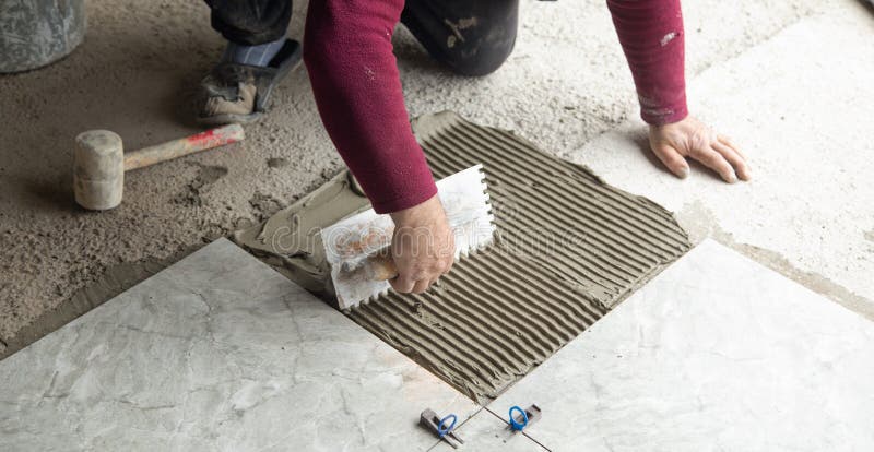 Laying Floor Ceramic Tile. Renovating the Floor Stock Photo - Image of ...