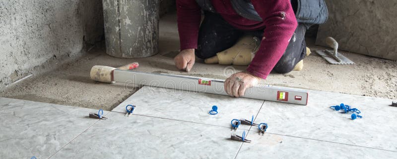 Laying Floor Ceramic Tile. Renovating the Floor Stock Image - Image of ...