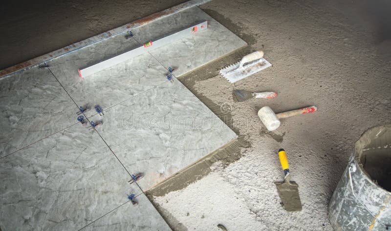 Laying Floor Ceramic Tile. Tools for Renovating Floor Stock Image ...