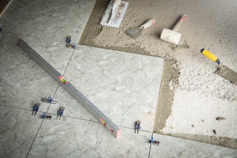Laying Floor Ceramic Tile. Tools for Renovating Floor Stock Image ...